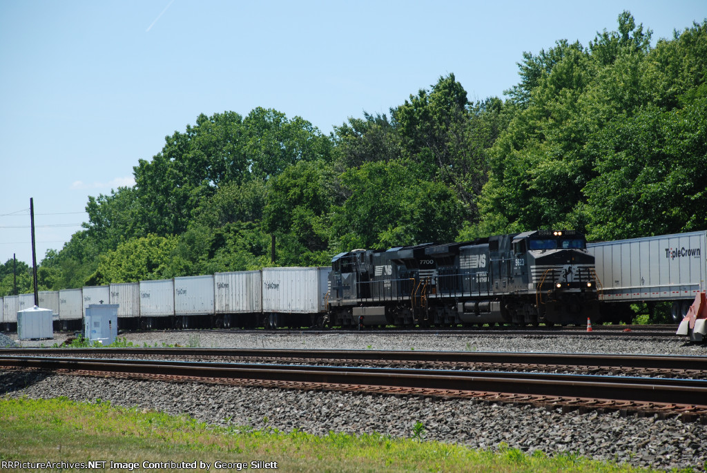 NS 9623 passes an eastbound road railer.